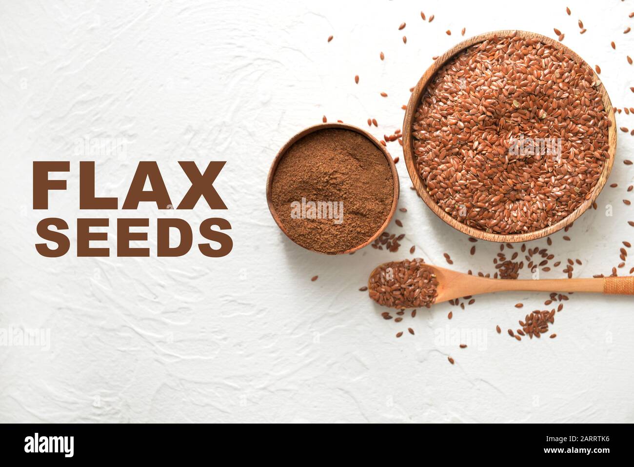 Bowls with flax seeds, powder and spoon on white background Stock Photo - Alamy