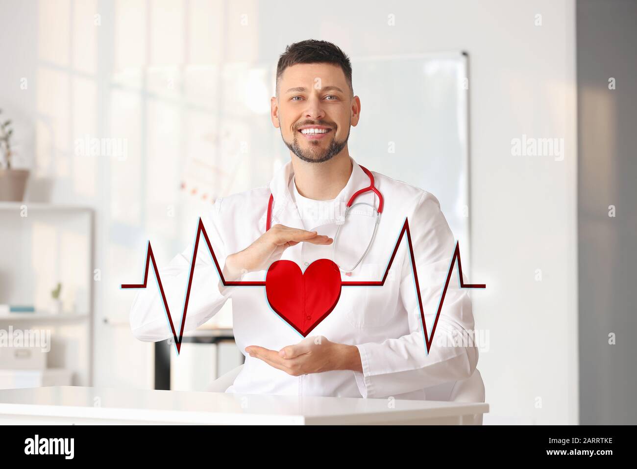 Male cardiologist with drawn heart and cardiogram in modern clinic ...