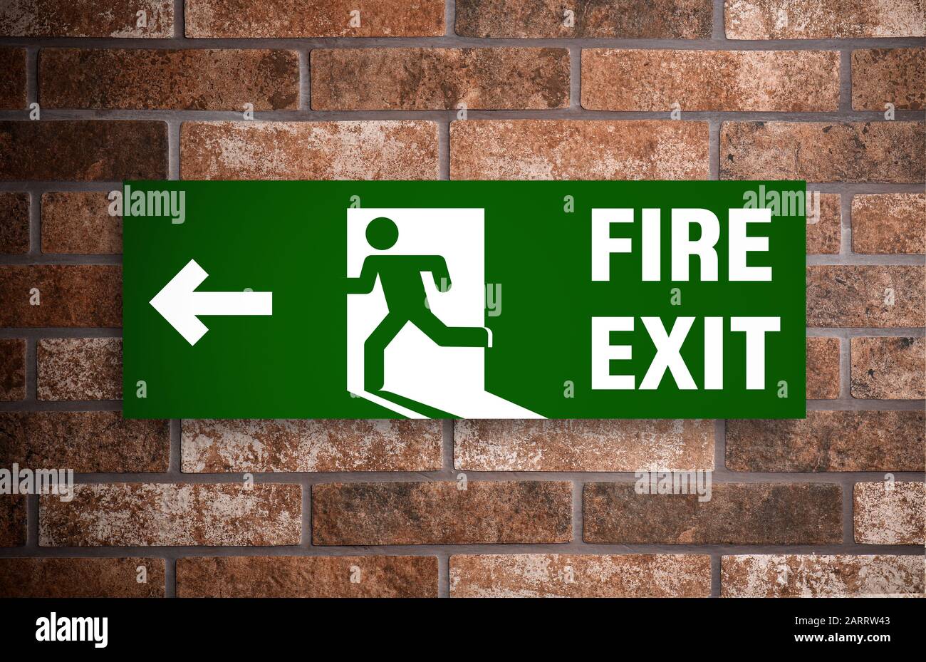 Sign of emergency fire exit on brick wall Stock Photo - Alamy