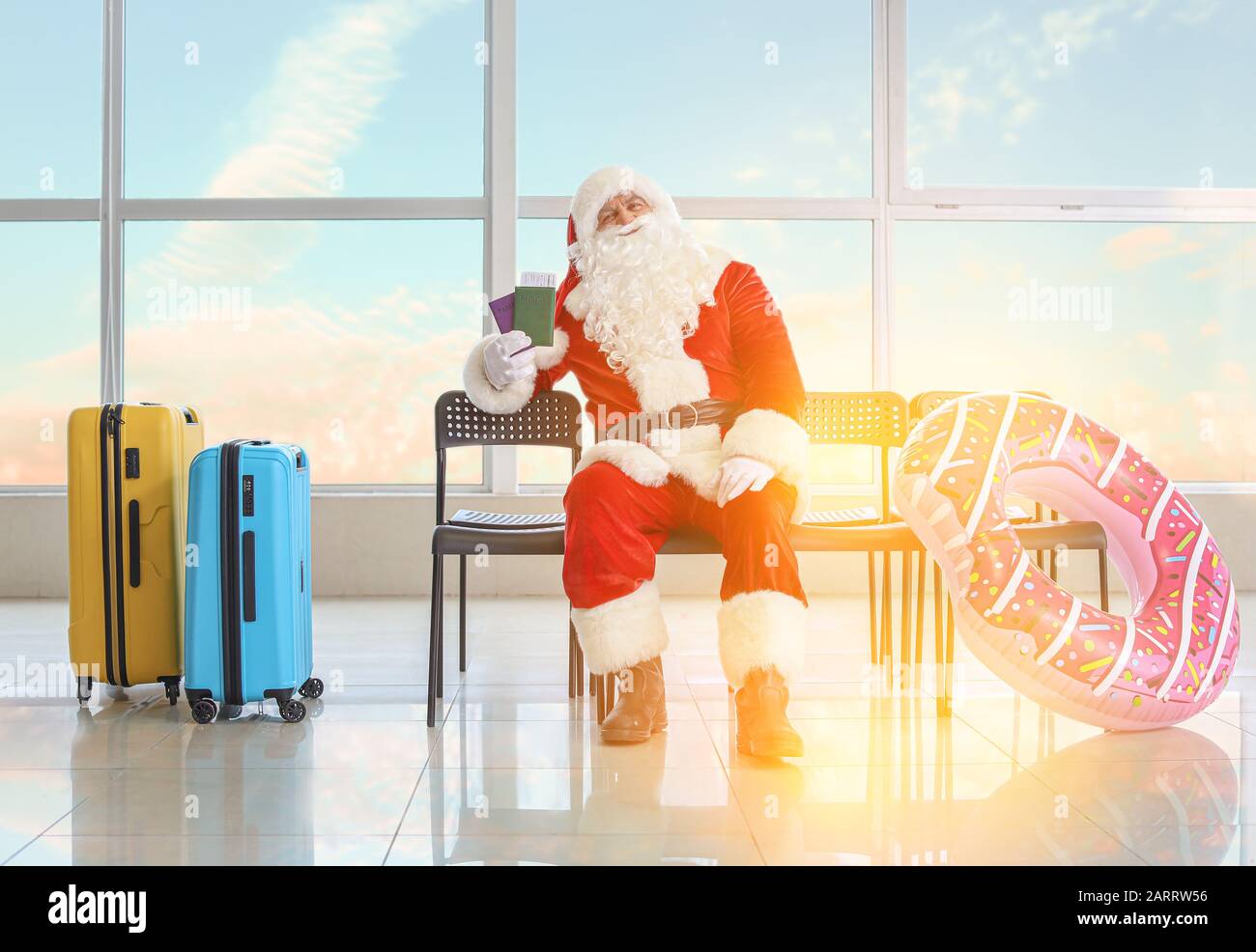 Santa Claus with luggage waiting for his flight at the airport. Concept ...