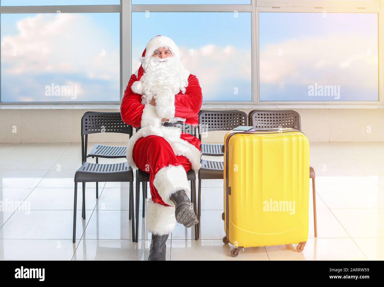 Santa Claus with luggage waiting for his flight at the airport. Concept ...