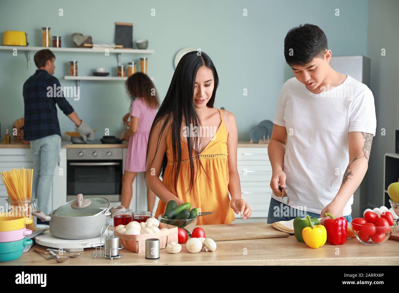 Happy Asian couple cooking together in kitchen Stock Photo - Alamy