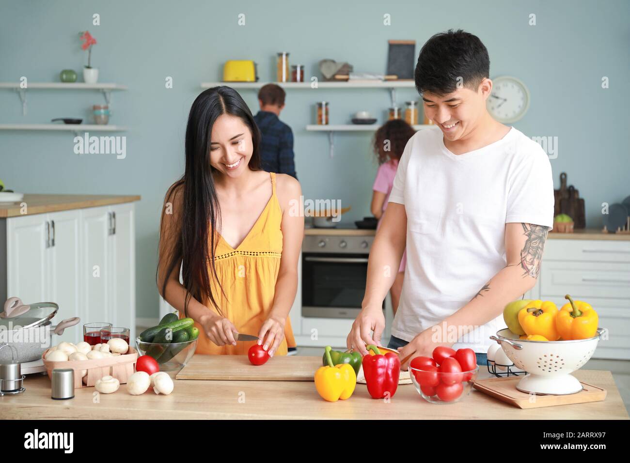 Happy Asian couple cooking together in kitchen Stock Photo - Alamy