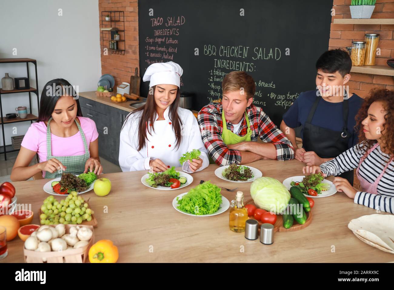 Female chef and group of young people during cooking classes Stock ...