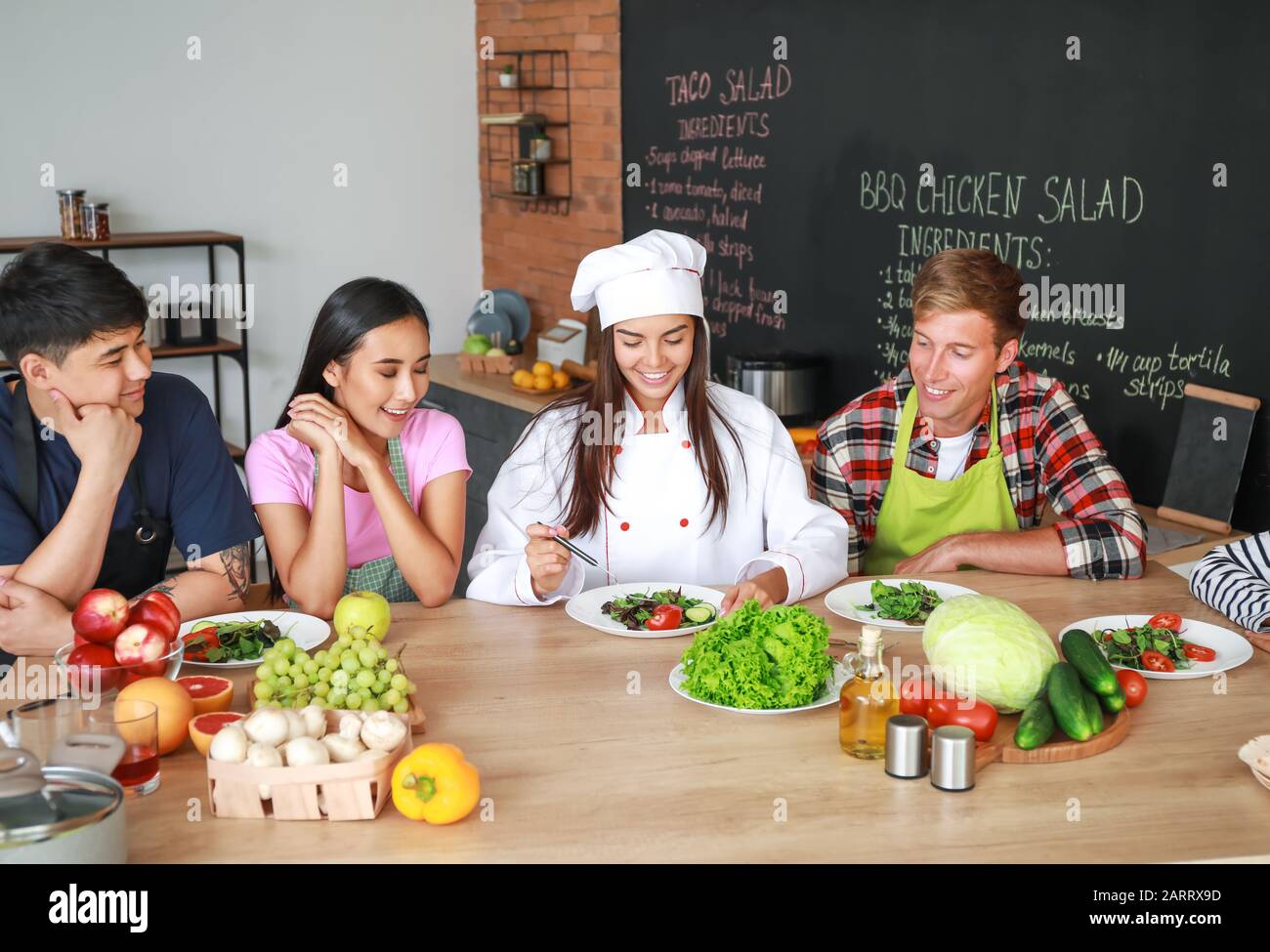 Female chef and group of young people during cooking classes Stock ...