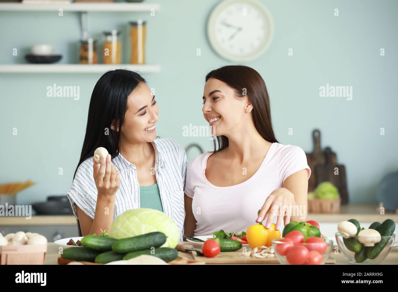 Beautiful women cooking together in kitchen Stock Photo - Alamy
