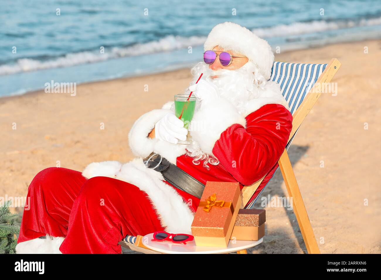 Happy Santa Claus resting at sea resort Stock Photo - Alamy