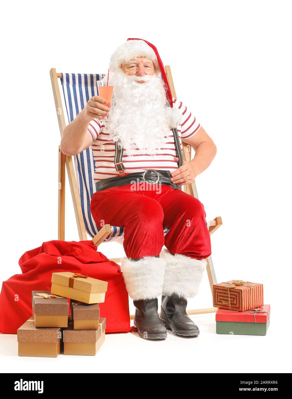 Santa Claus with gifts and cocktail sitting on beach chair against ...