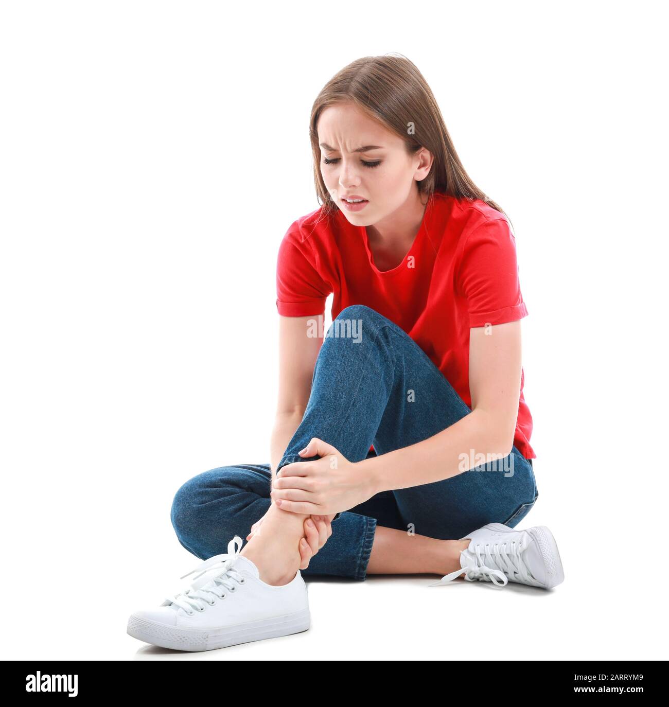 Young woman suffering from pain in leg on white background Stock Photo ...