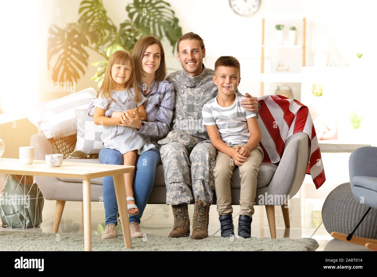 Happy military man with his family at home Stock Photo - Alamy