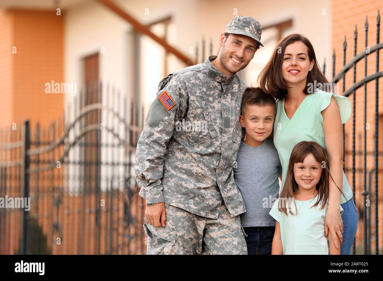 Happy military man with his family outdoors Stock Photo - Alamy