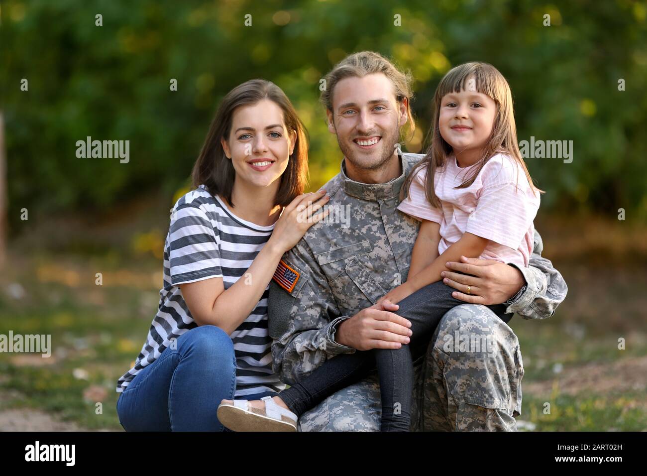 Happy military man with his family outdoors Stock Photo - Alamy