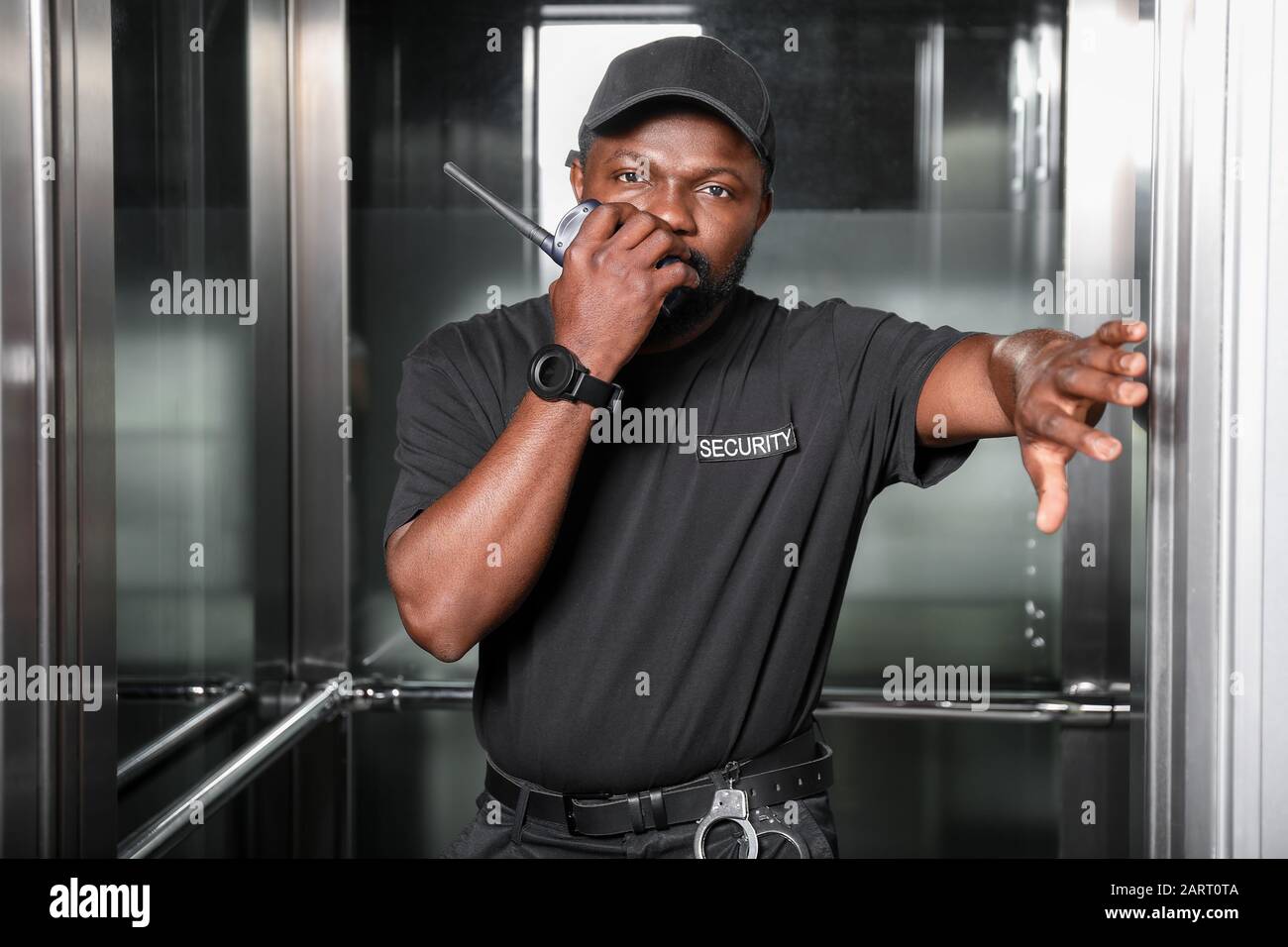 African-American security guard in elevator Stock Photo - Alamy