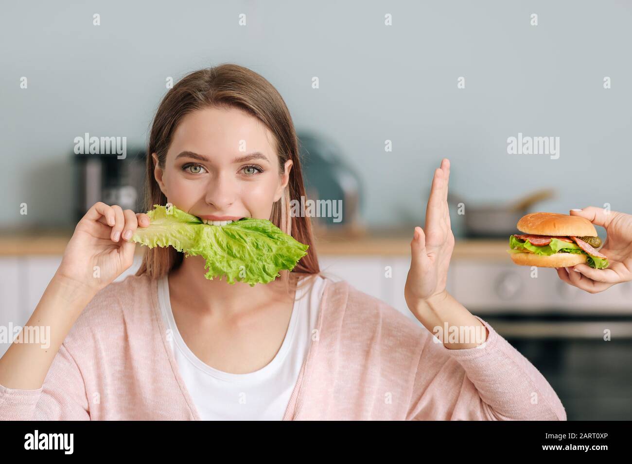 Woman refusing to eat unhealthy food in kitchen. Diet concept Stock ...