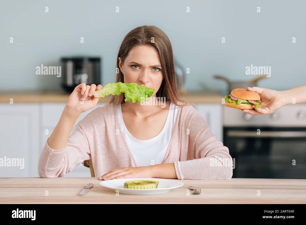 Sad woman eating salad hi-res stock photography and images - Alamy