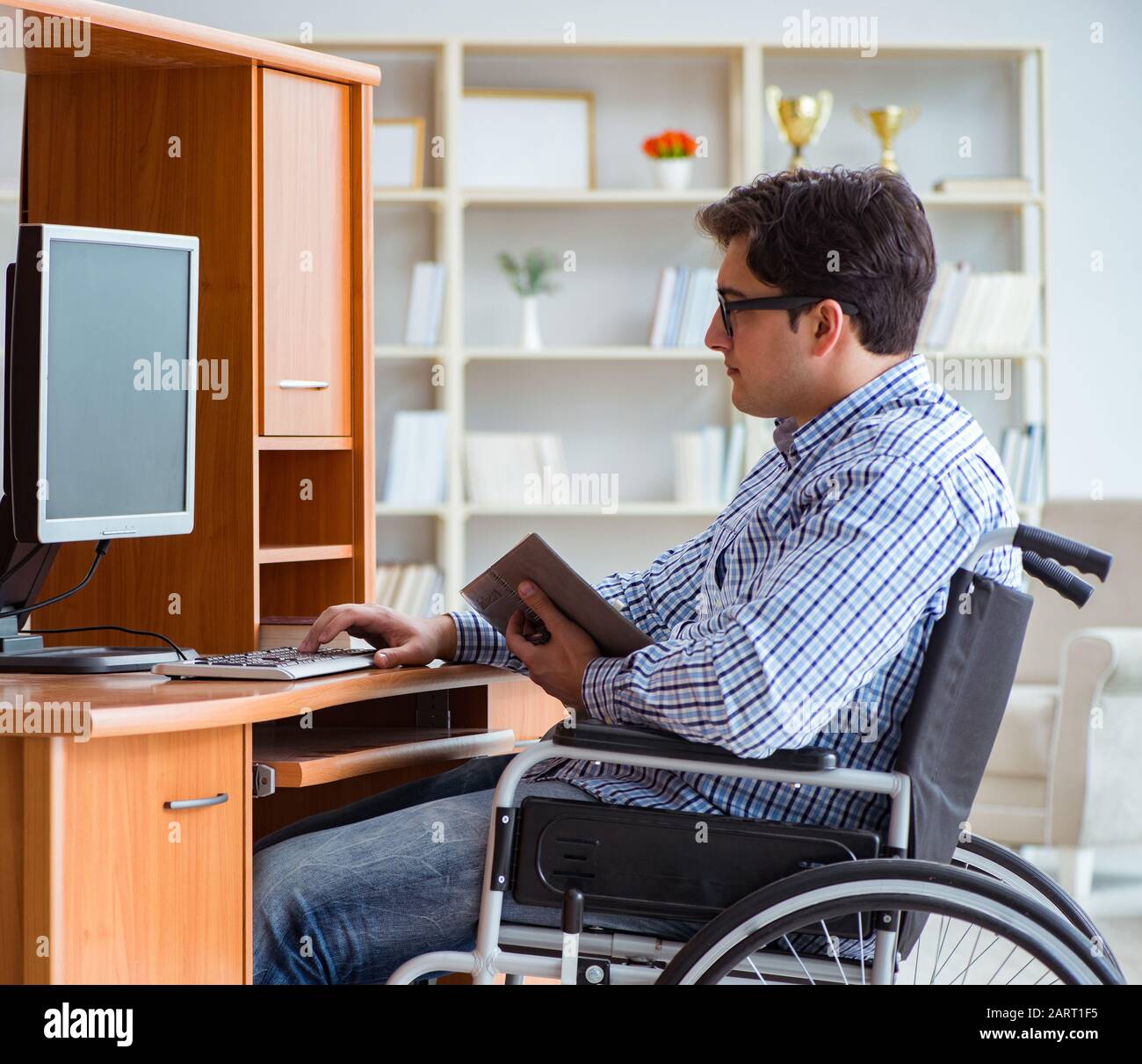 The disabled student studying at home on wheelchair Stock Photo - Alamy