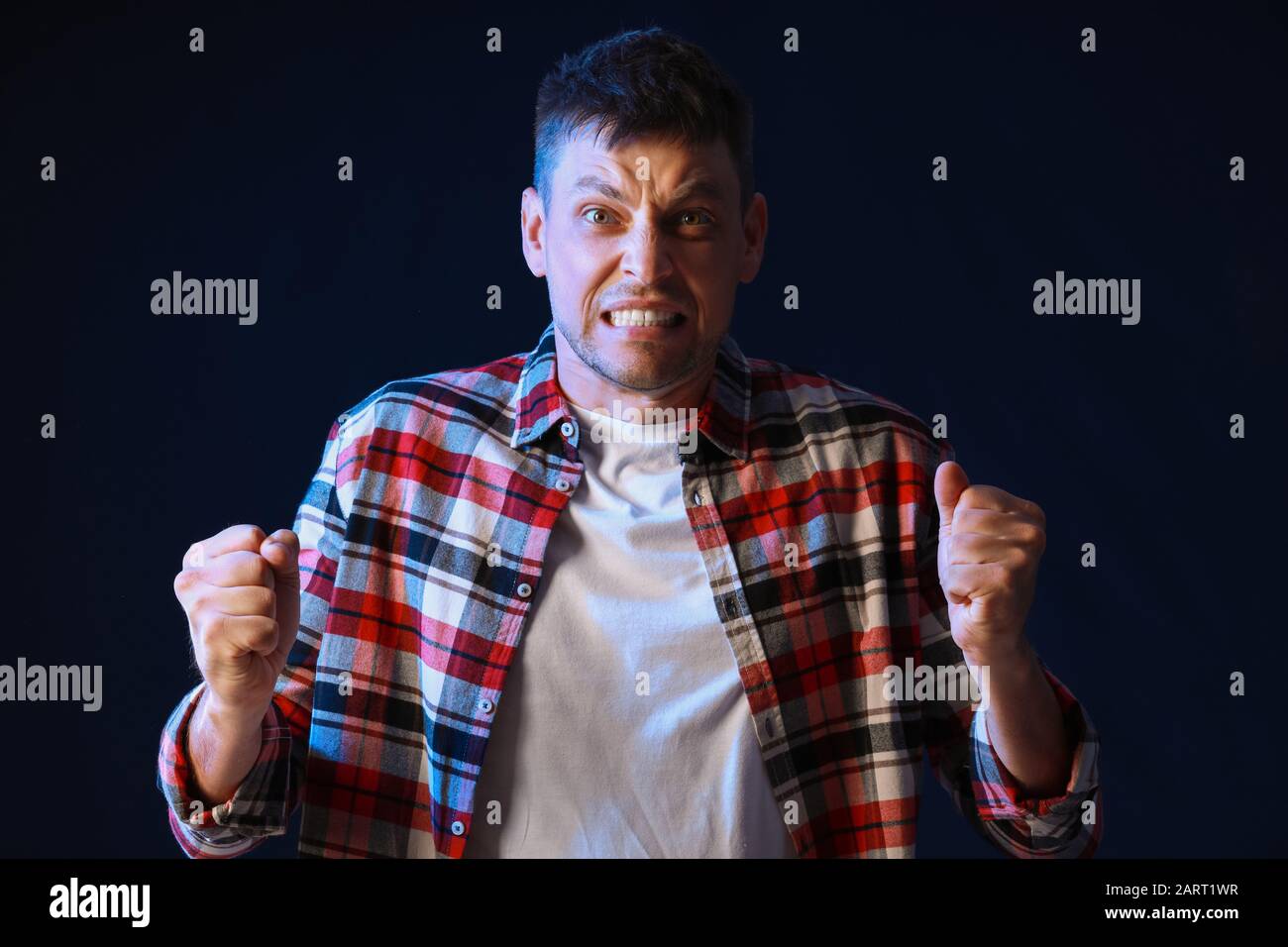 Portrait of angry man on dark background Stock Photo - Alamy