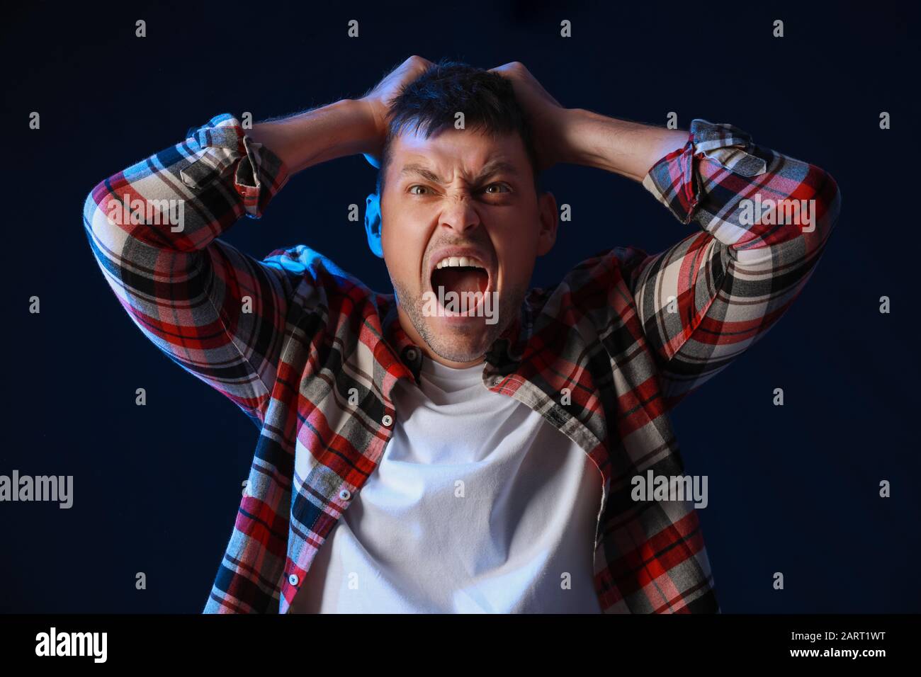 Portrait of angry man on dark background Stock Photo - Alamy
