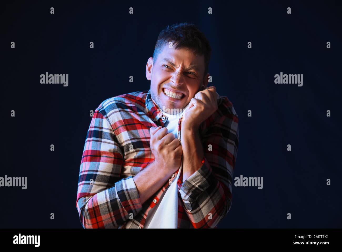 Portrait of angry man on dark background Stock Photo - Alamy