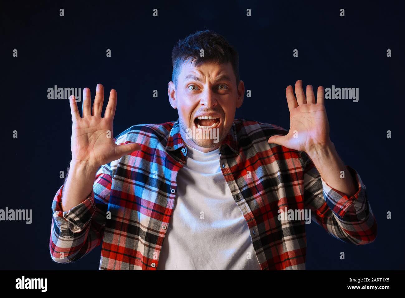 Portrait of angry man on dark background Stock Photo - Alamy