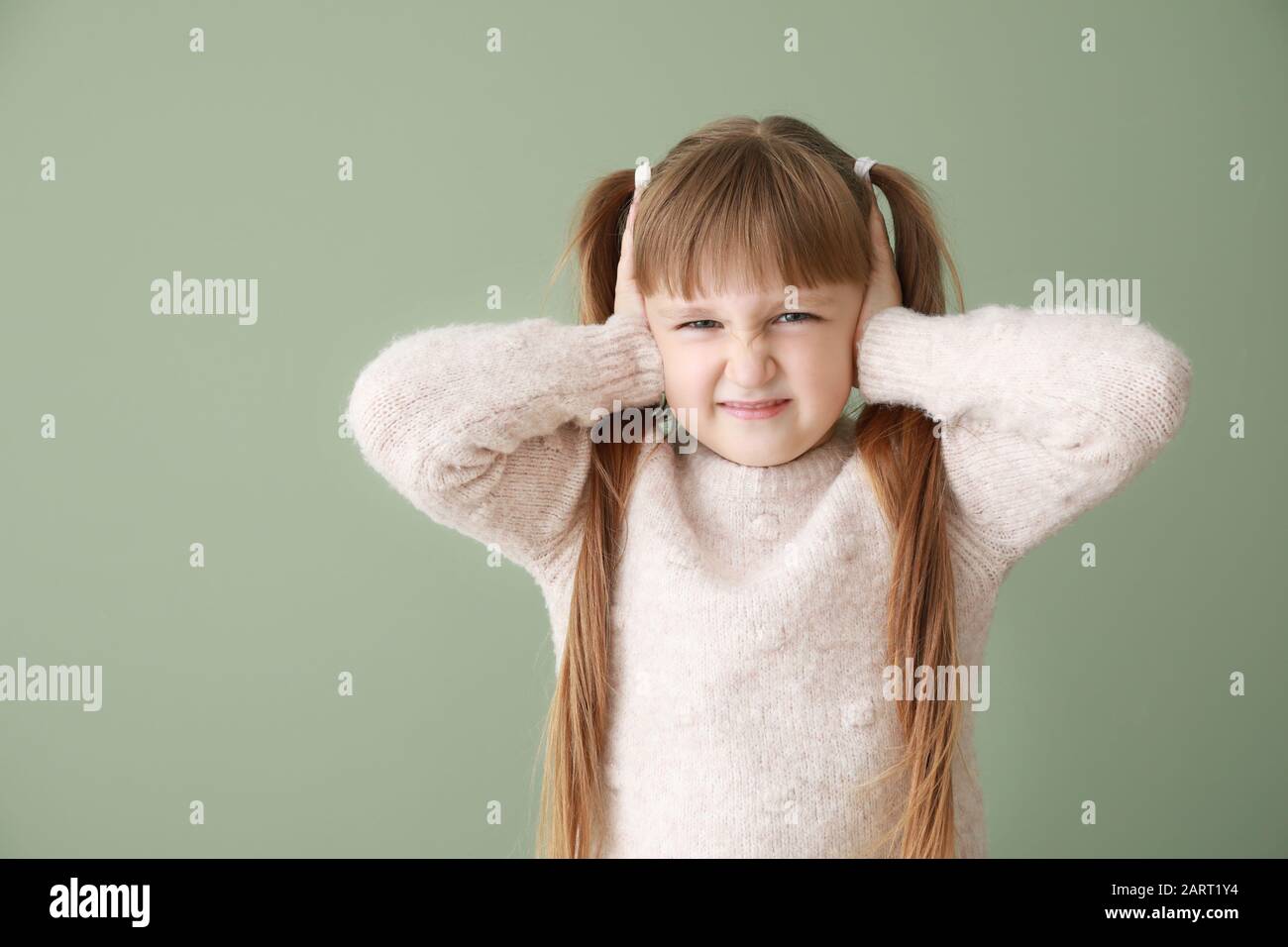 Portrait of angry little girl on color background Stock Photo - Alamy