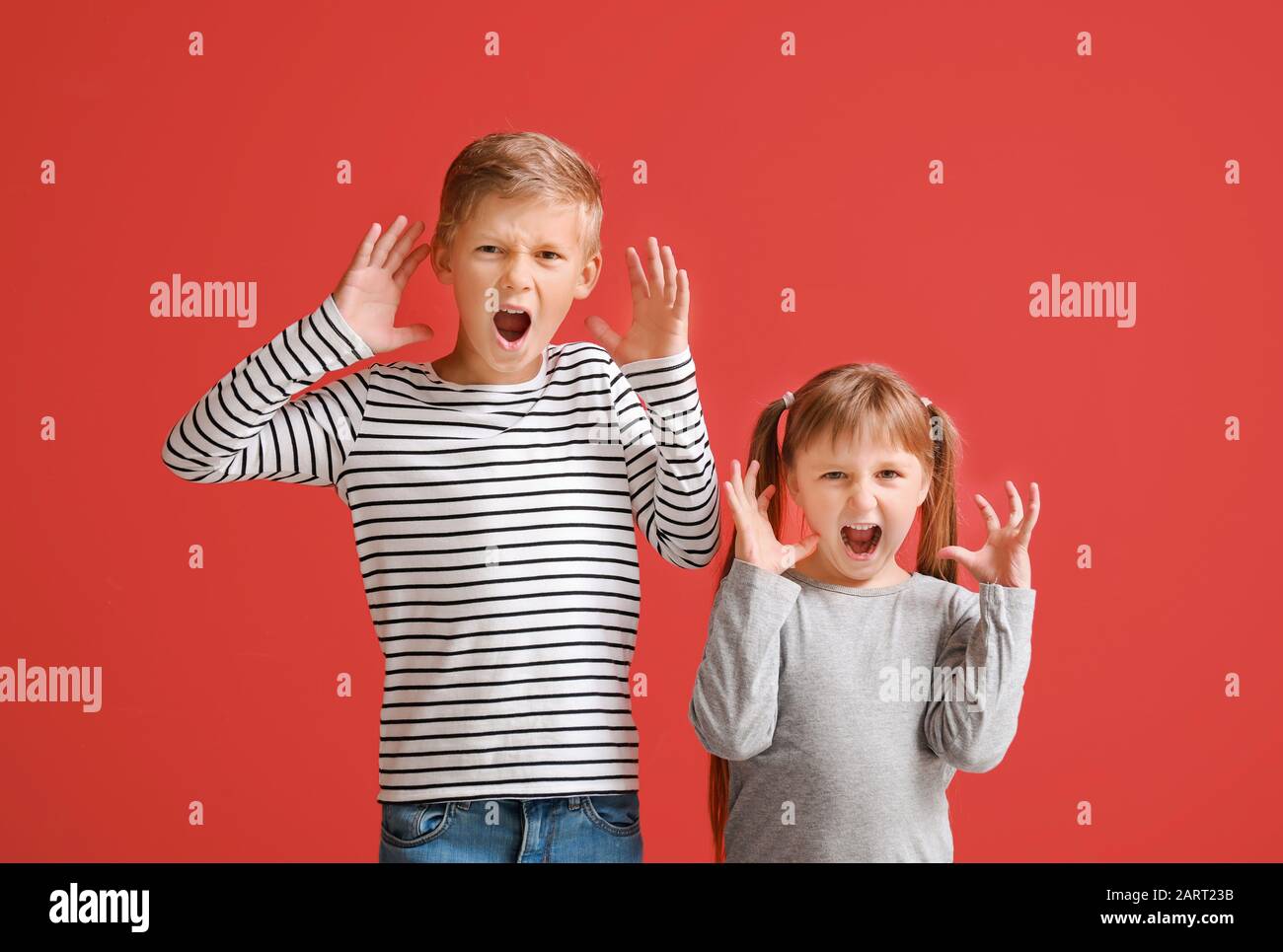 Portrait of angry little children on color background Stock Photo - Alamy