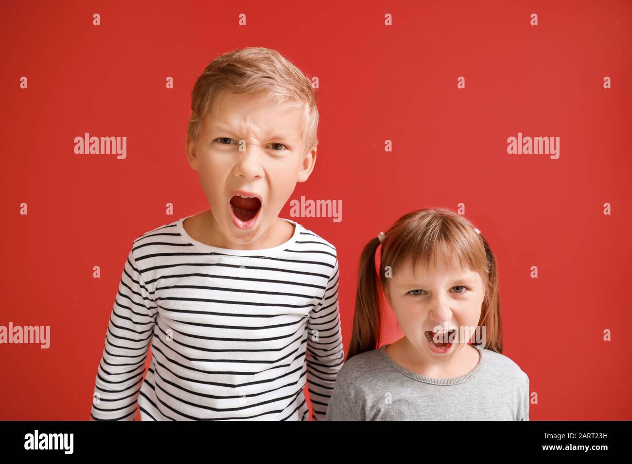 Portrait of angry little children on color background Stock Photo - Alamy