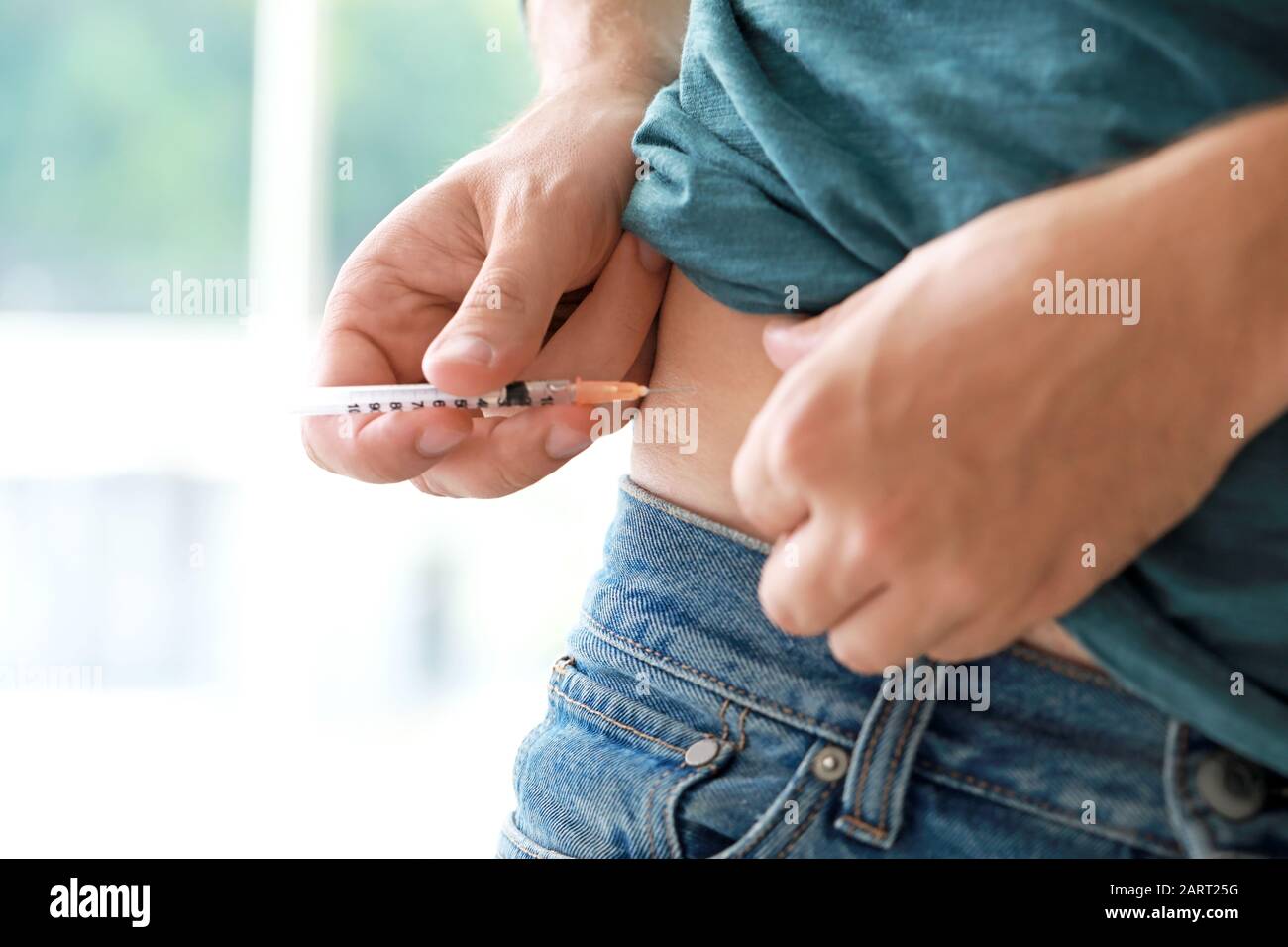 Diabetic man giving himself insulin injection at home, closeup Stock ...