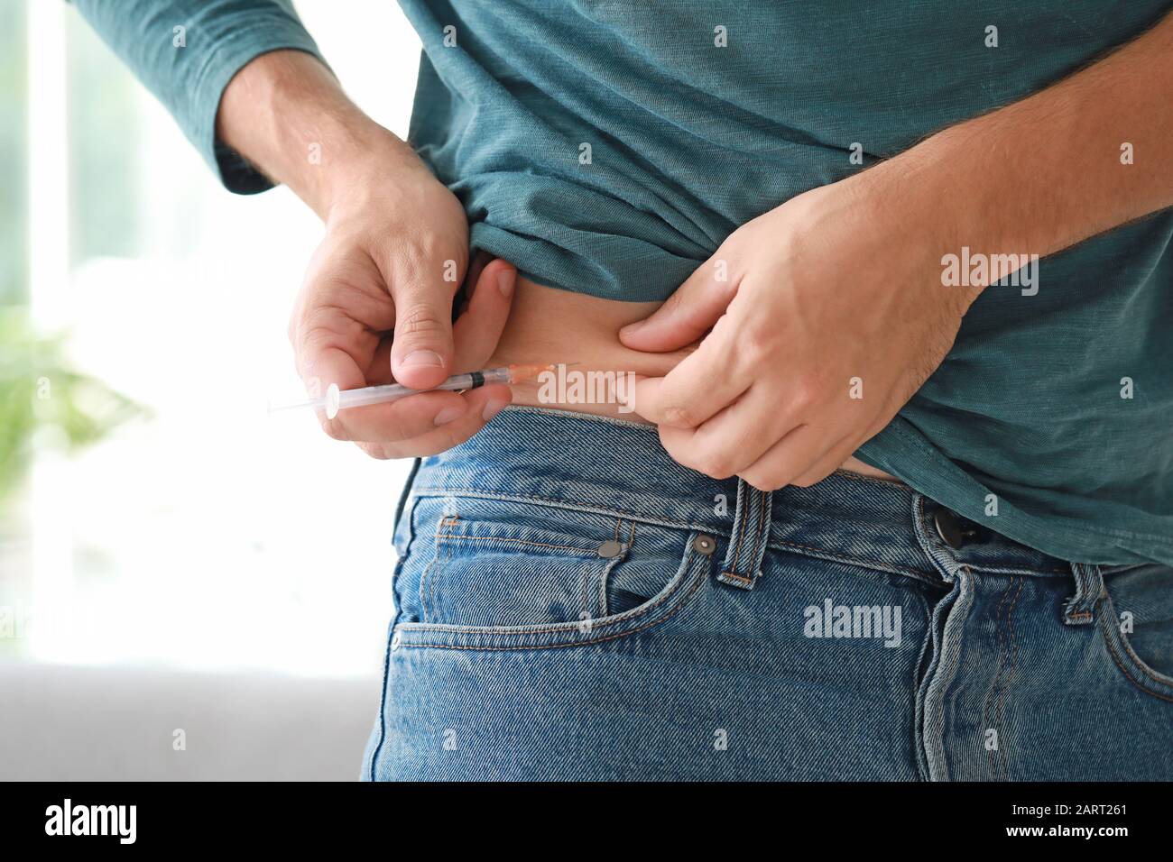 Diabetic man giving himself insulin injection at home, closeup Stock ...