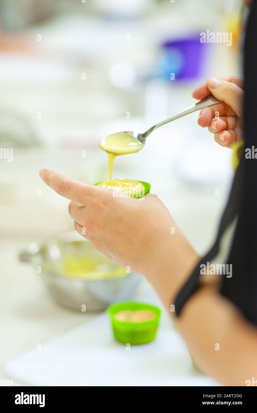 The process of making cupcakes. Creation of cakes by professional ...