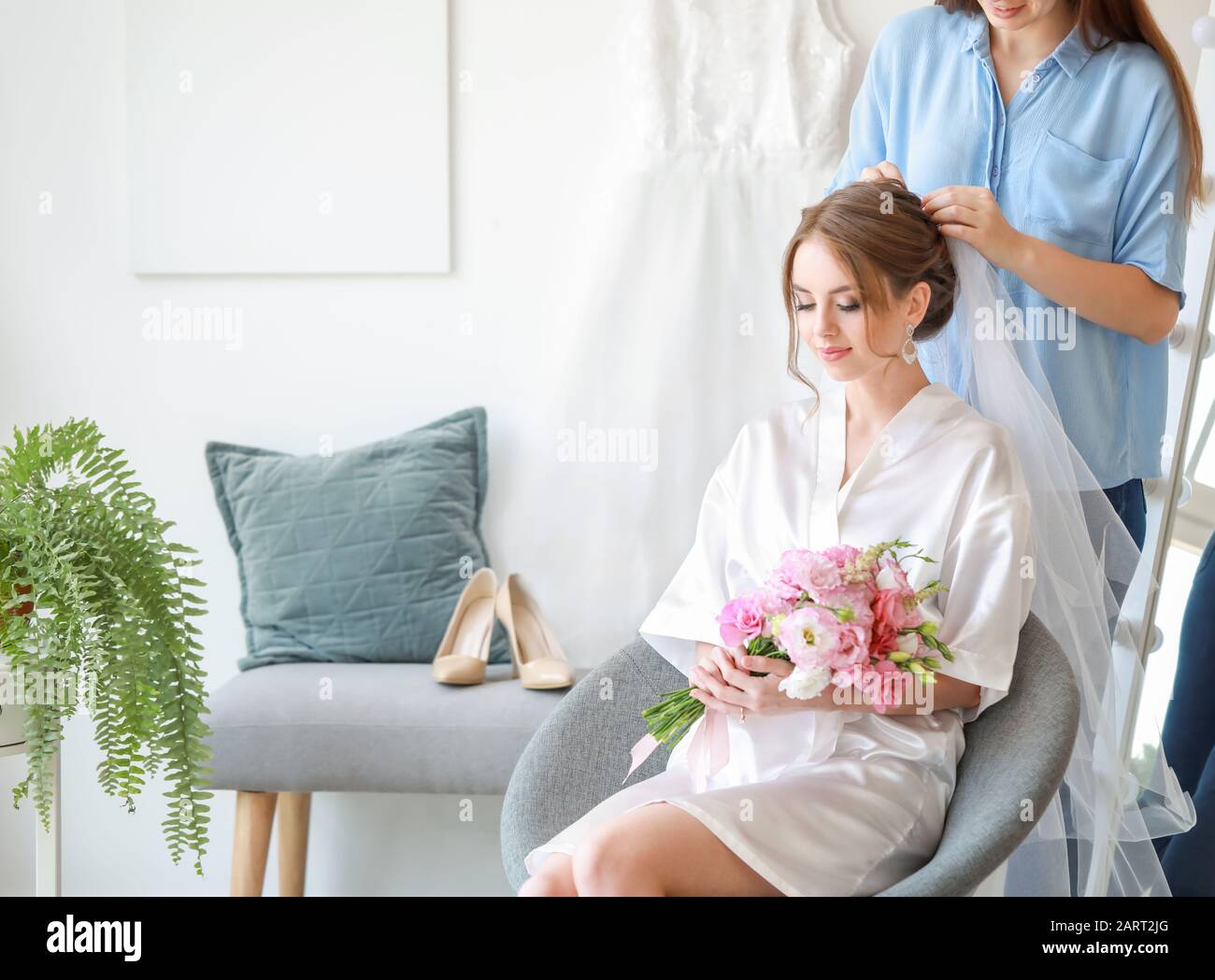 Professional hairdresser working with young bride at home Stock Photo ...