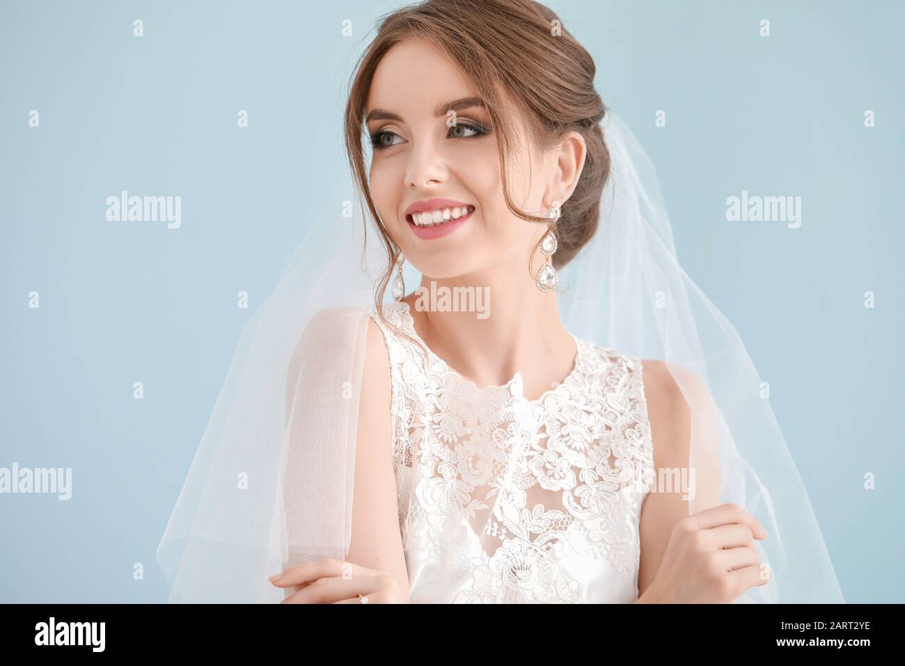 Portrait of beautiful young bride on light background Stock Photo - Alamy