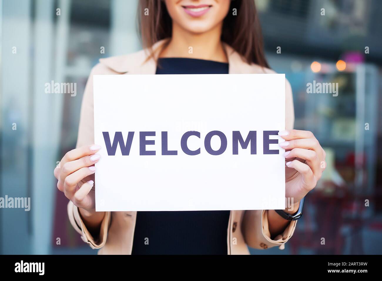 Women business with the poster with welcome message Stock Photo - Alamy