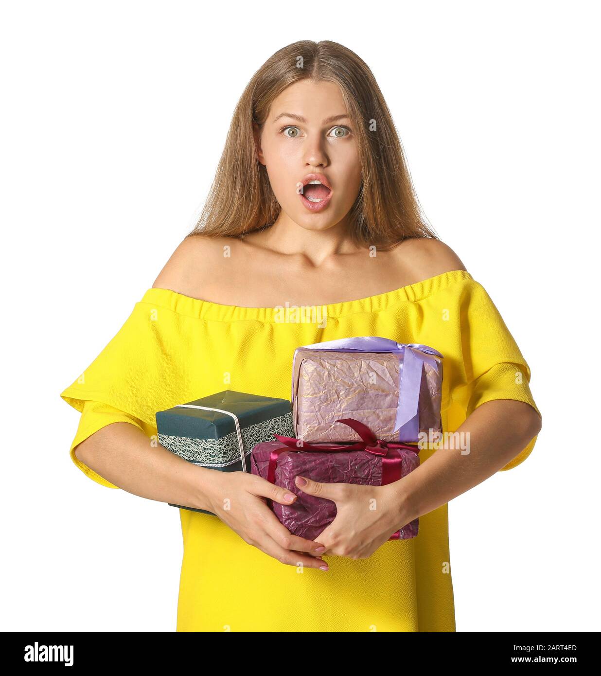 Surprised young woman with gifts on white background Stock Photo - Alamy