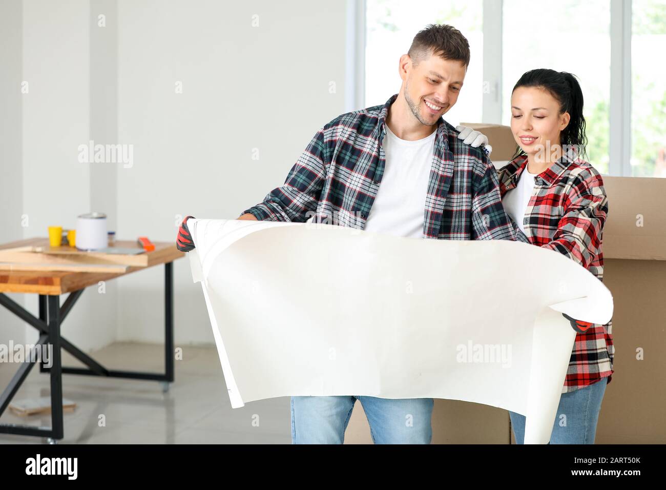 Happy couple planning design of their new house Stock Photo - Alamy