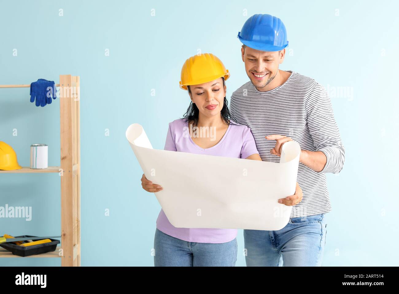 Happy couple planning design of their new house Stock Photo - Alamy