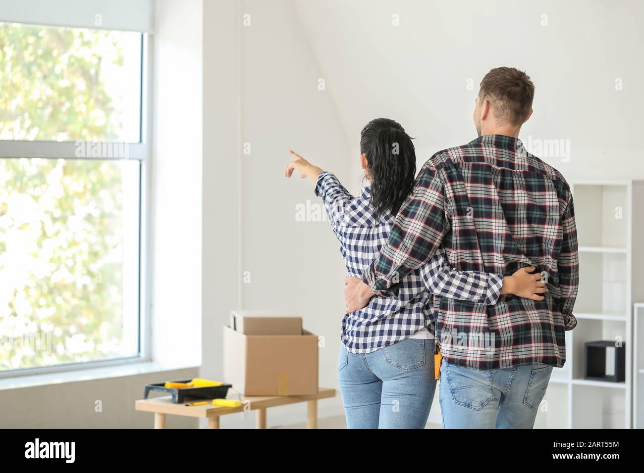 Happy couple planning design of their new house, back view Stock Photo ...