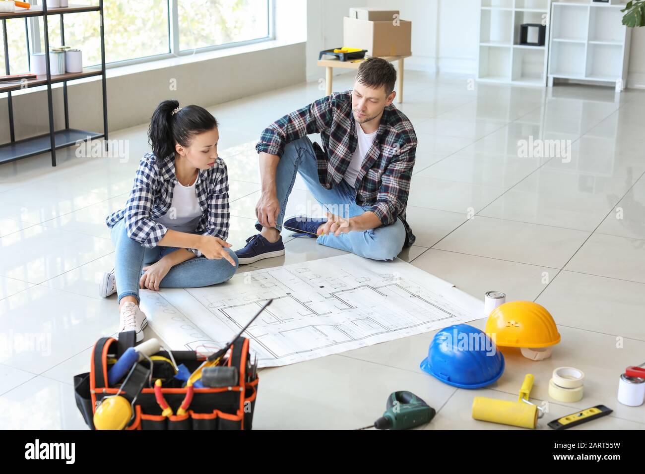 Happy couple planning design of their new house Stock Photo - Alamy