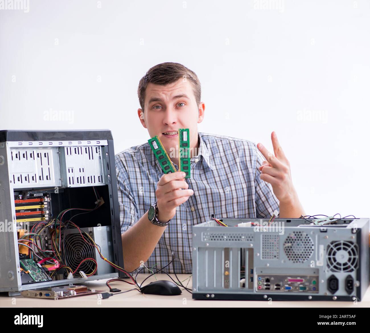 The young technician repairing computer in workshop Stock Photo - Alamy