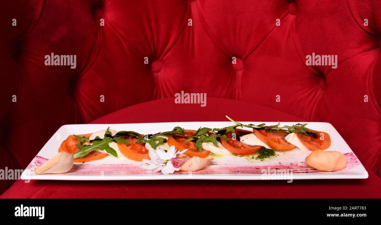 Starter from traditional Italian cuisine on red quilted background ...