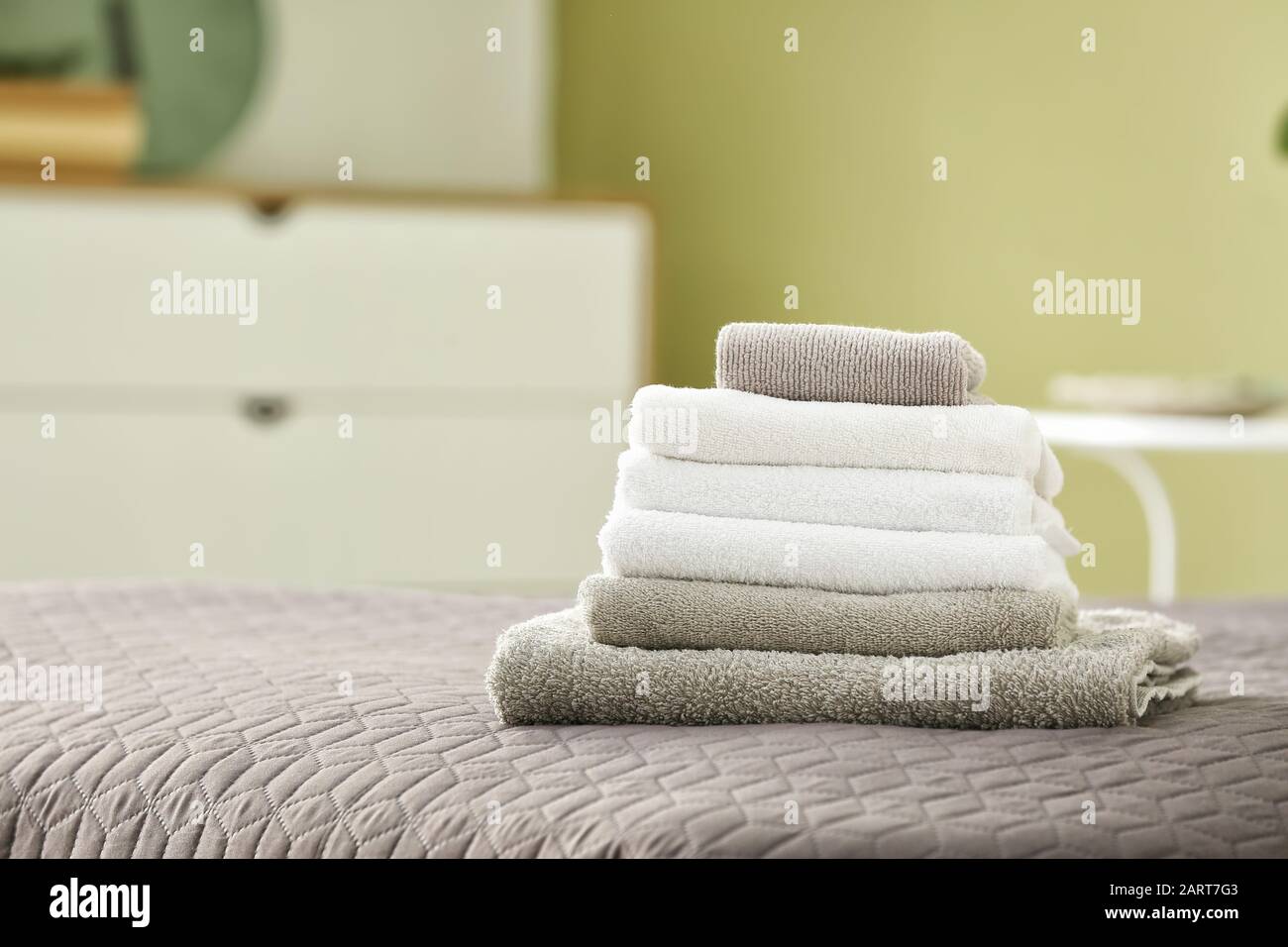 Stack of clean towels on bed Stock Photo - Alamy