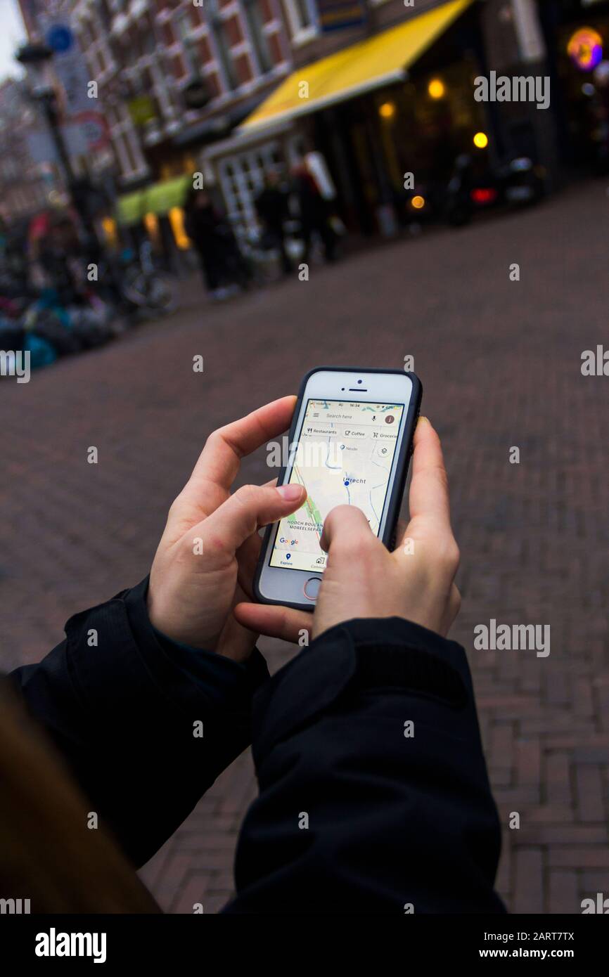Tourist girl using navigation app on a smart phone making search on a ...