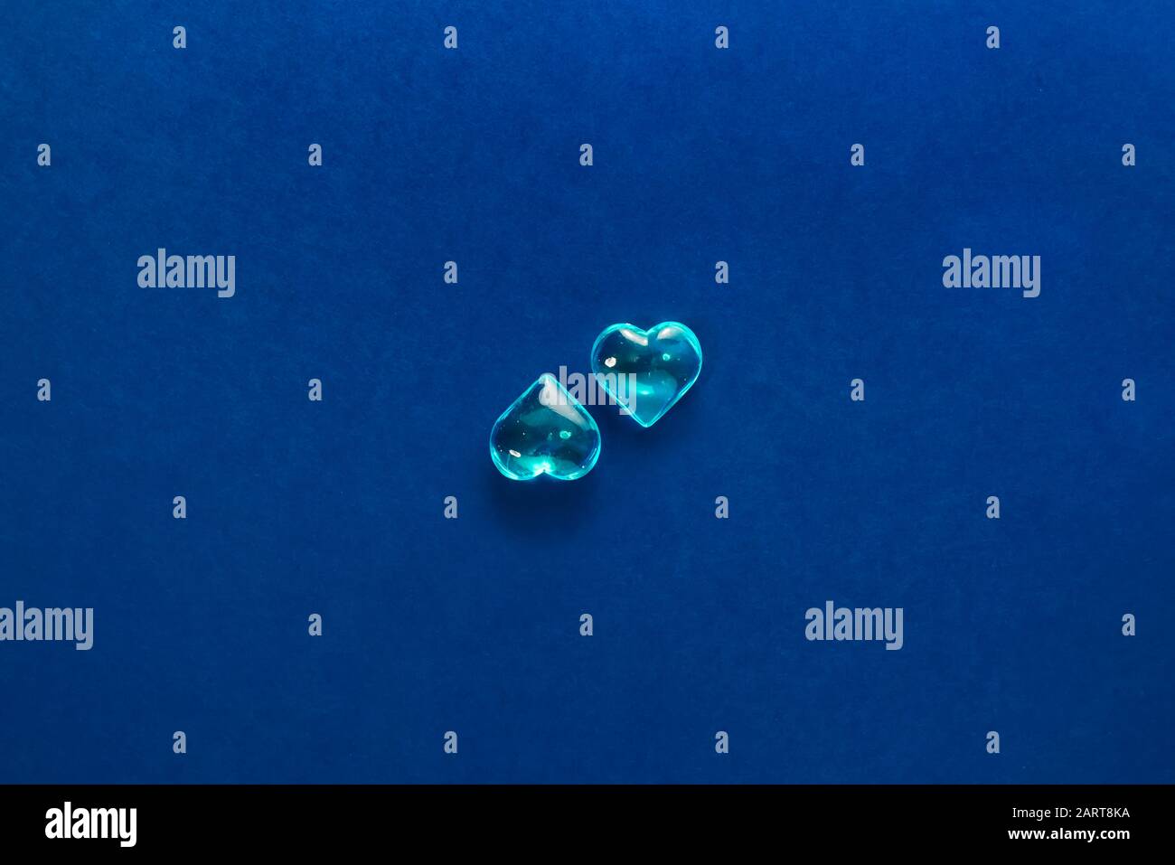 Glass blue hearts on a classic blue background. Symbol of LGBT love ...