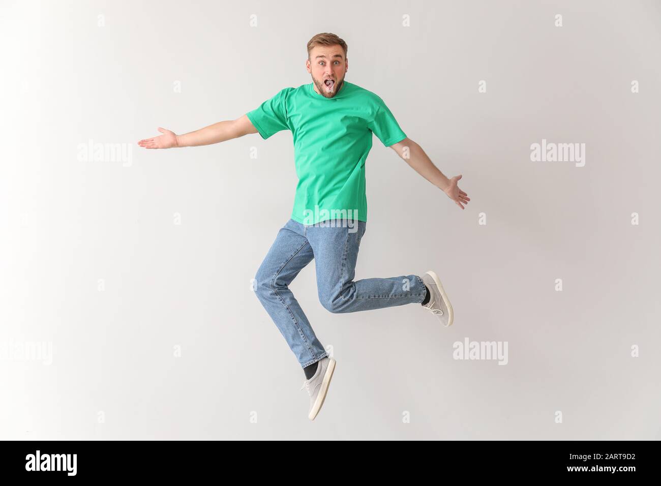 Surprised young man jumping hi-res stock photography and images - Alamy