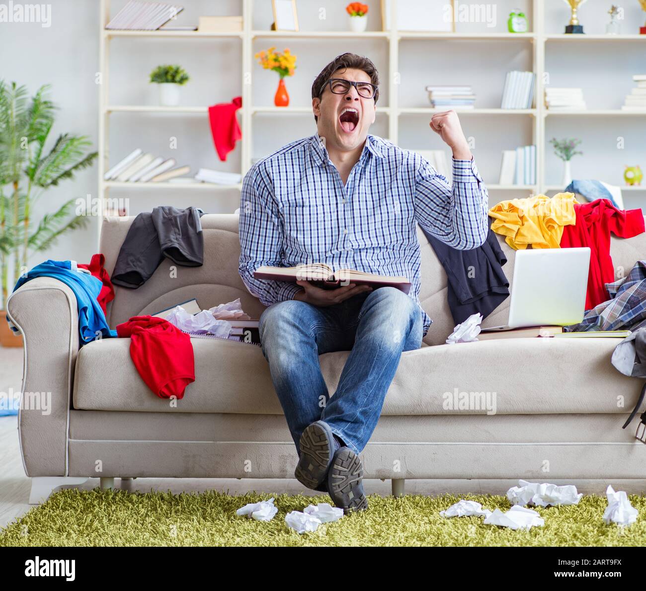 The young man working studying in messy room Stock Photo - Alamy