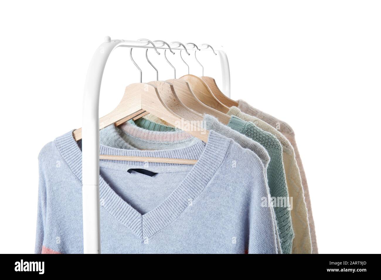 Rack with hanging clothes on white background Stock Photo - Alamy