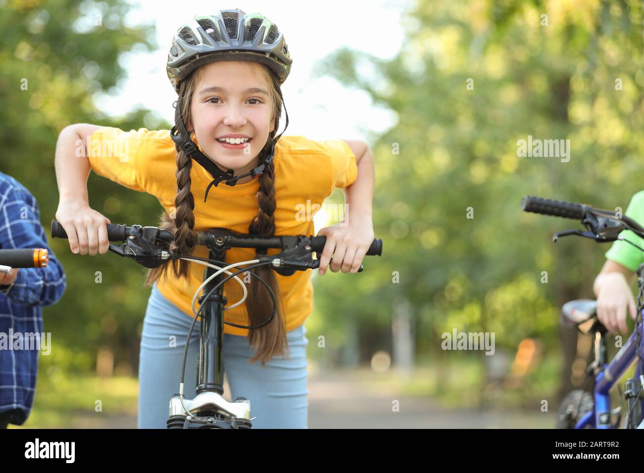 Cute children riding bicycles outdoors Stock Photo - Alamy