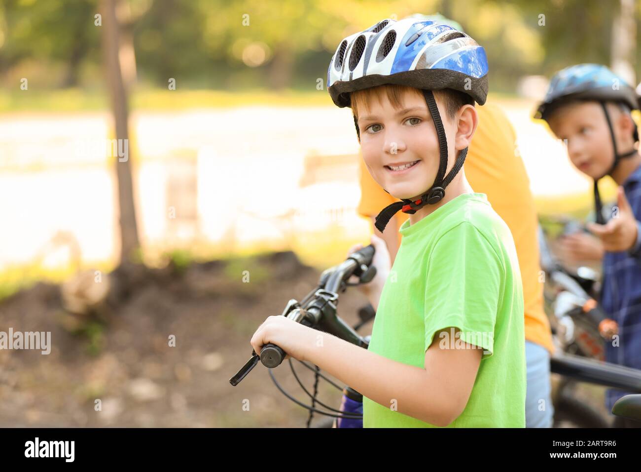 Cute boy riding bicycle outdoors Stock Photo - Alamy