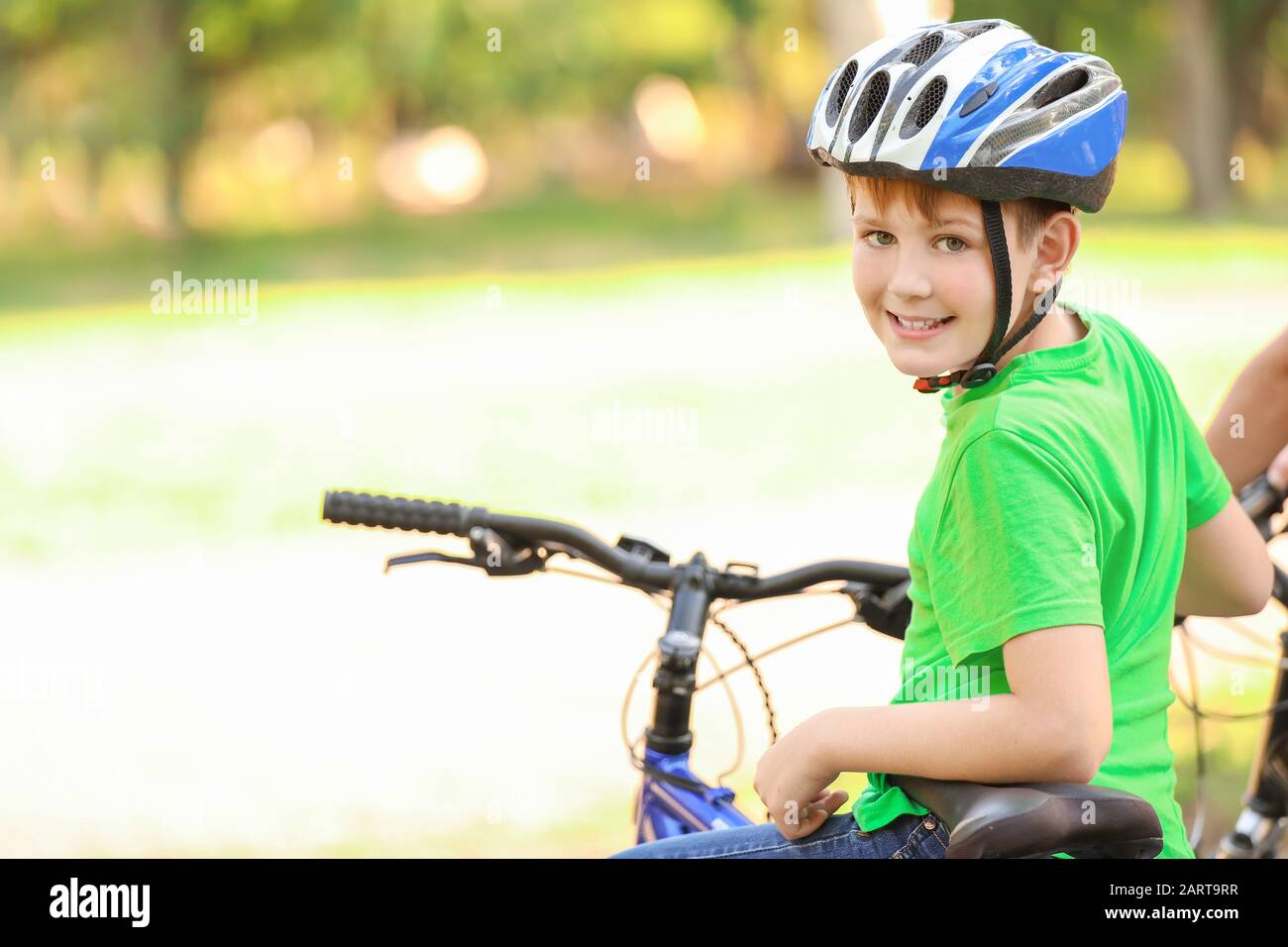 Cute boy riding bicycle outdoors Stock Photo - Alamy