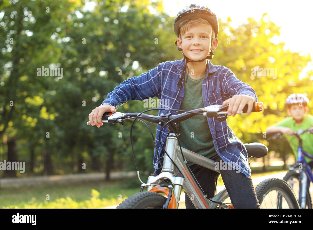 Cute boy riding bicycle outdoors Stock Photo - Alamy